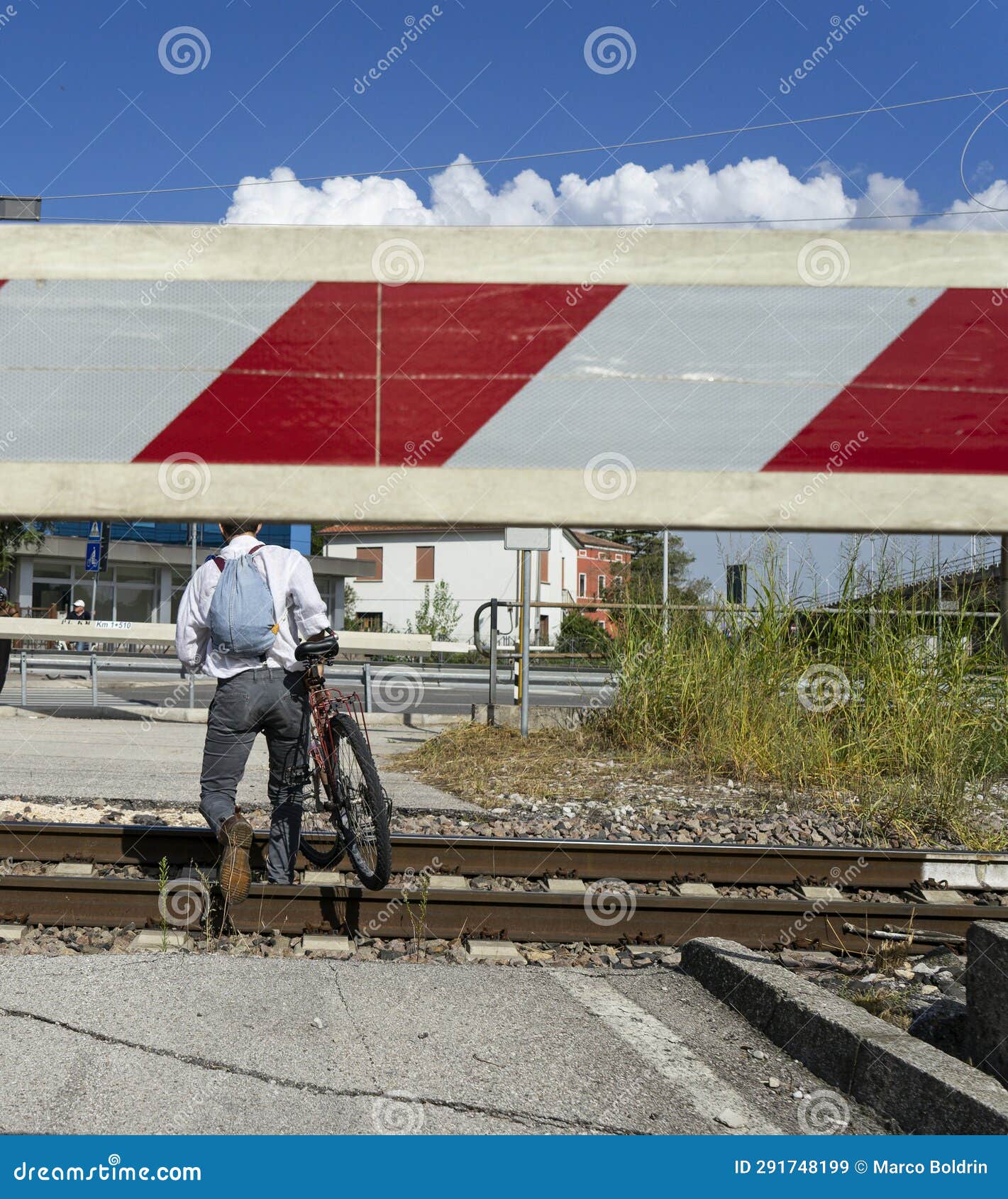 Man Crosses Train Tracks with Lowered Bar Stock Image - Image of ...