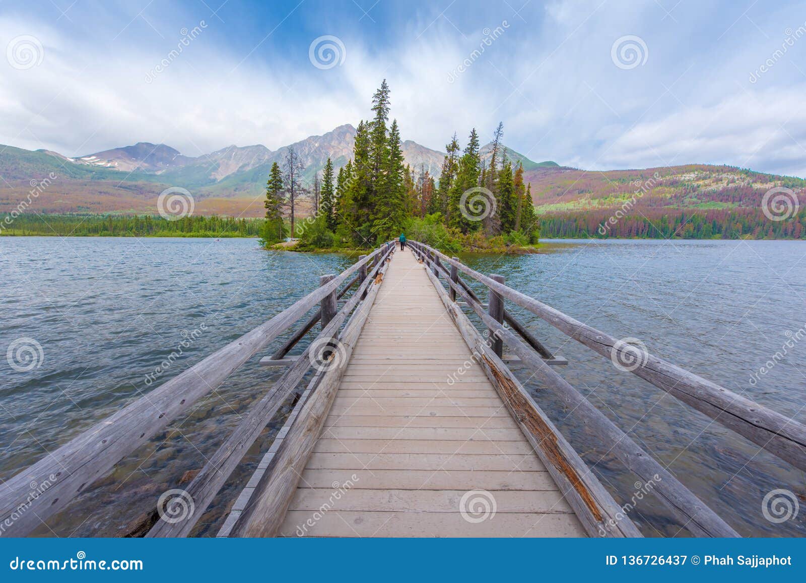 A Man Crossing the Bridge at the Pyramid Island in Alberta, Canada ...