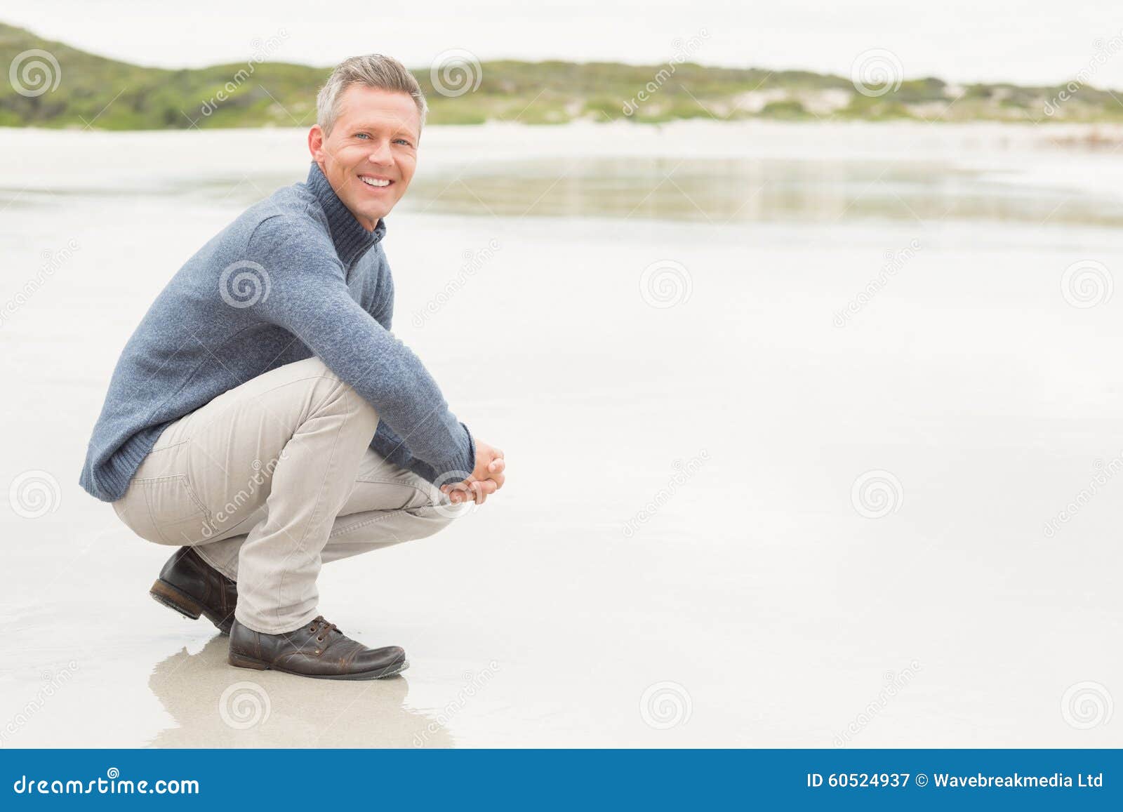 Man Crouched Down at the Shore Stock Image - Image of bright, outdoors ...