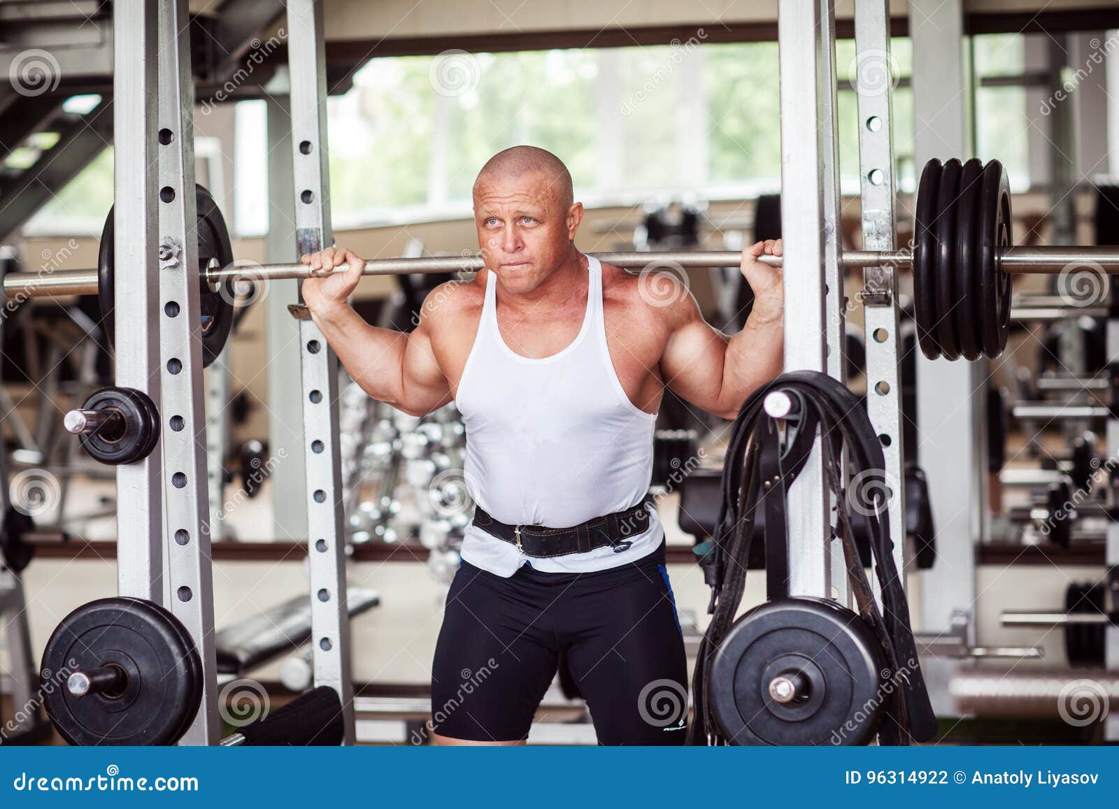 The Man Crouches with a Barbell Stock Photo - Image of muscular ...