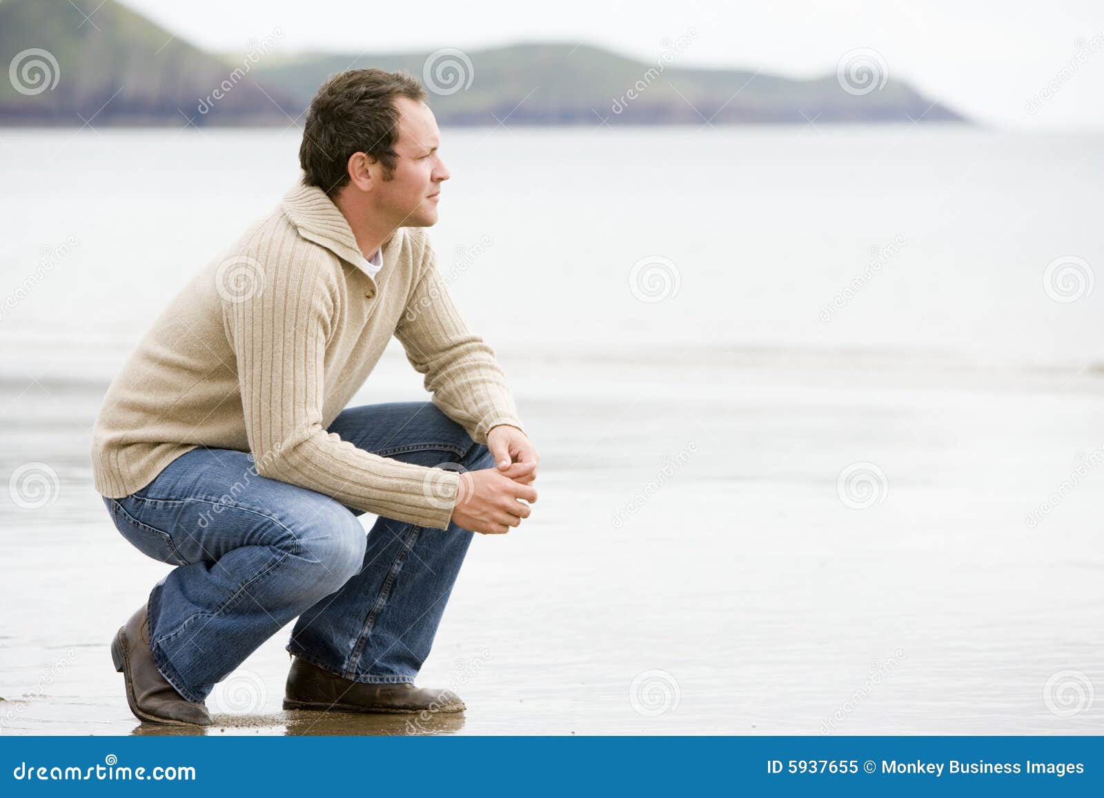Man crouching on beach stock image. Image of seaside, crouching - 5937655