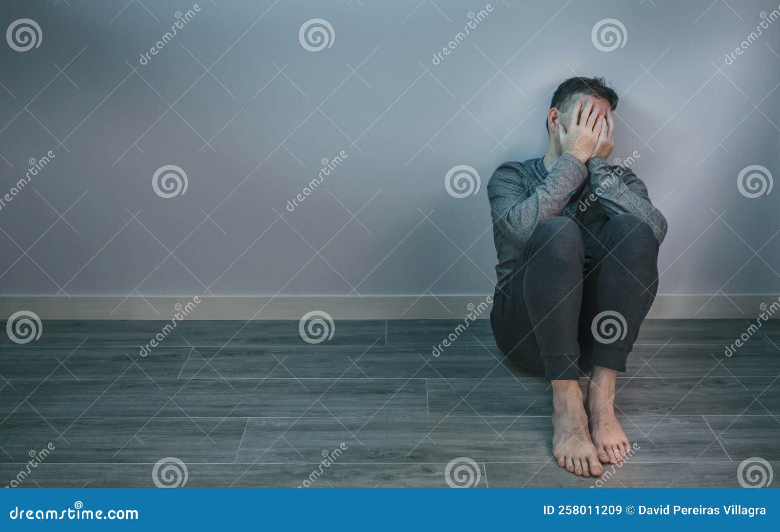 Man Crying while Covering His Face with Hands Sitting on the Floor ...