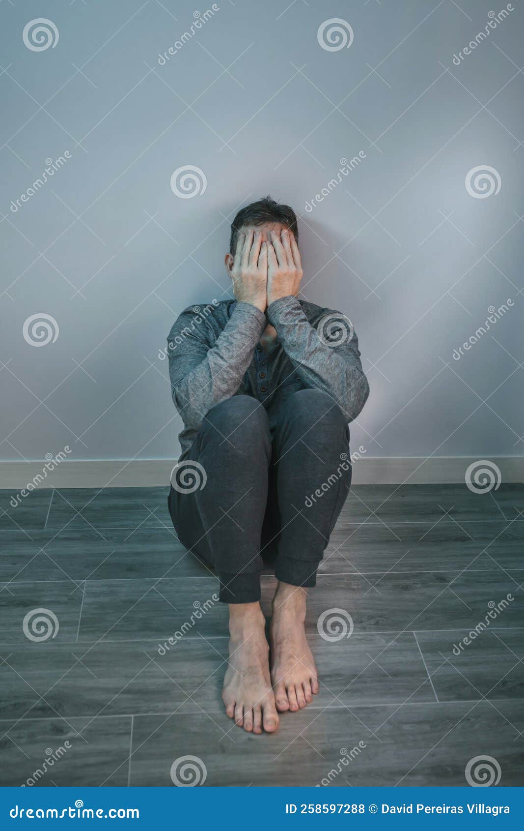 Man Crying while Covering His Face with Hands Sitting on the Floor ...