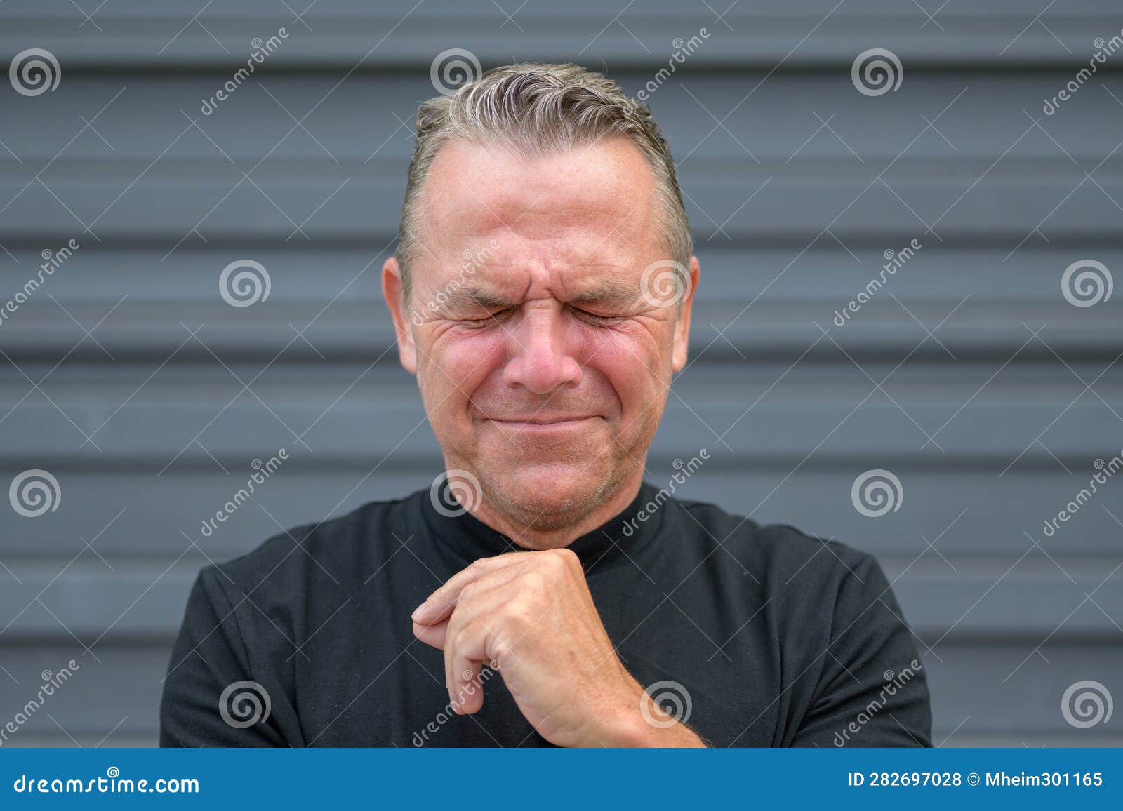 Man Crying from Sadness, Anger or Trouble in Front of a Blue Wall Stock ...