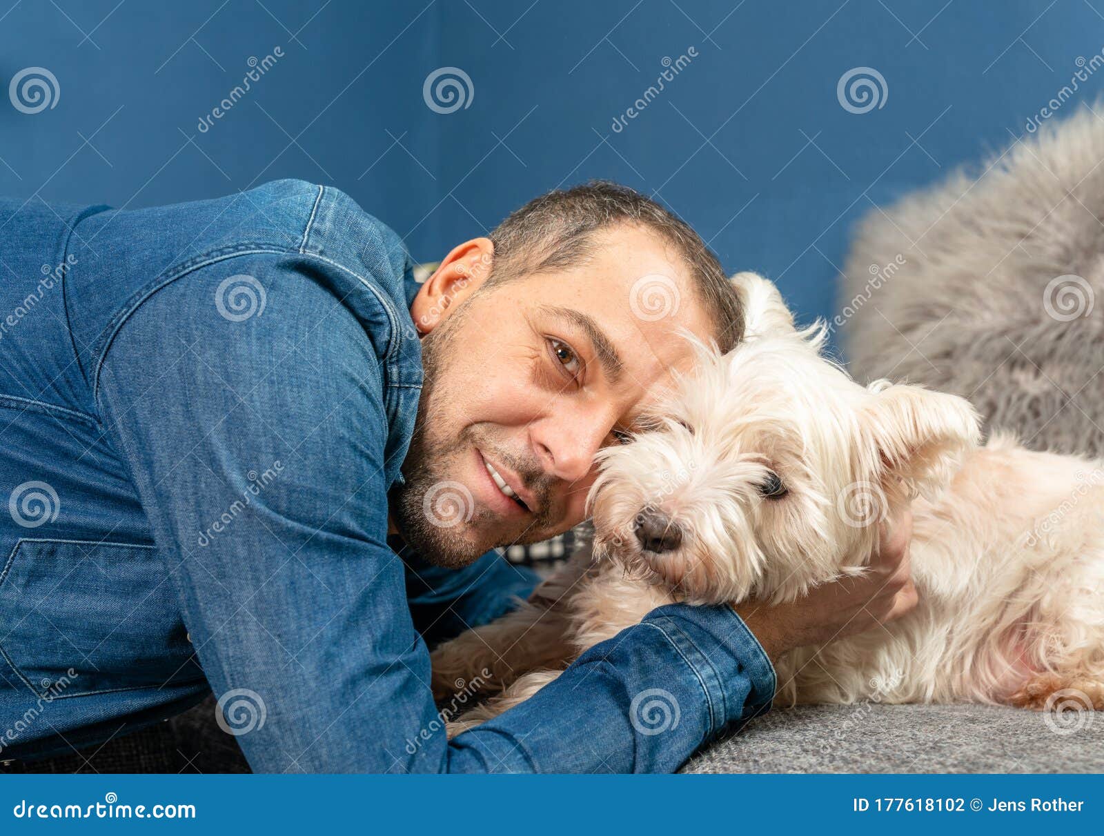Man Cuddles with His Dog on the Couch Stock Photo - Image of authentic ...