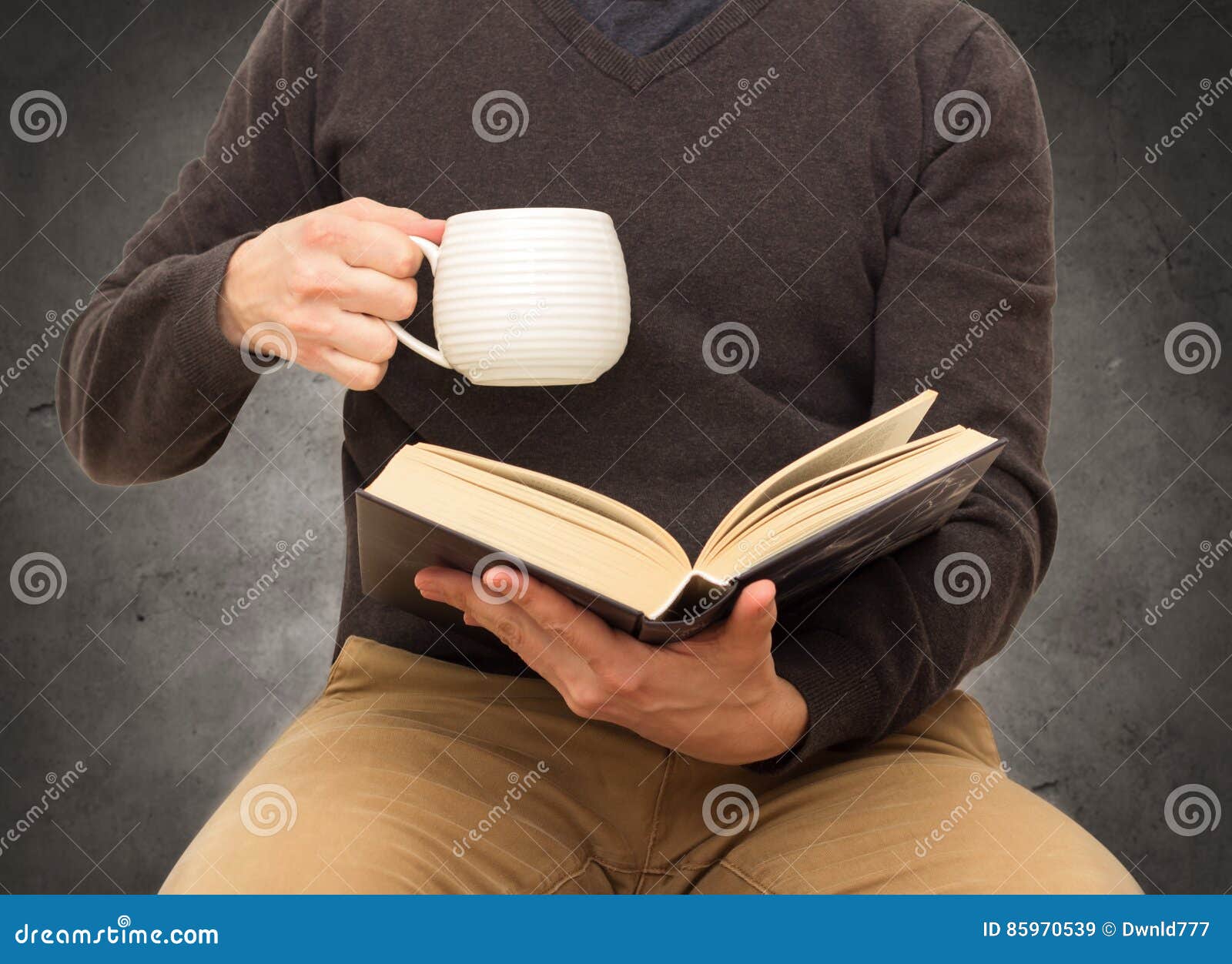 Man with cup reading book stock image. Image of body - 85970539