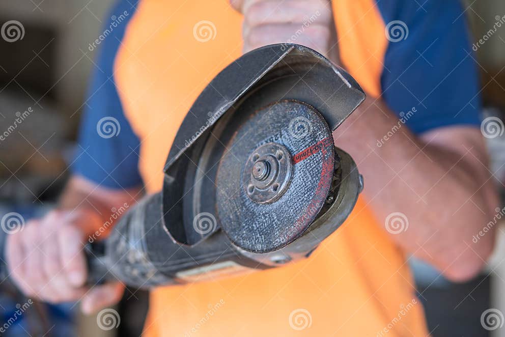 Man with a cut grinder stock photo. Image of hand, person - 194932362