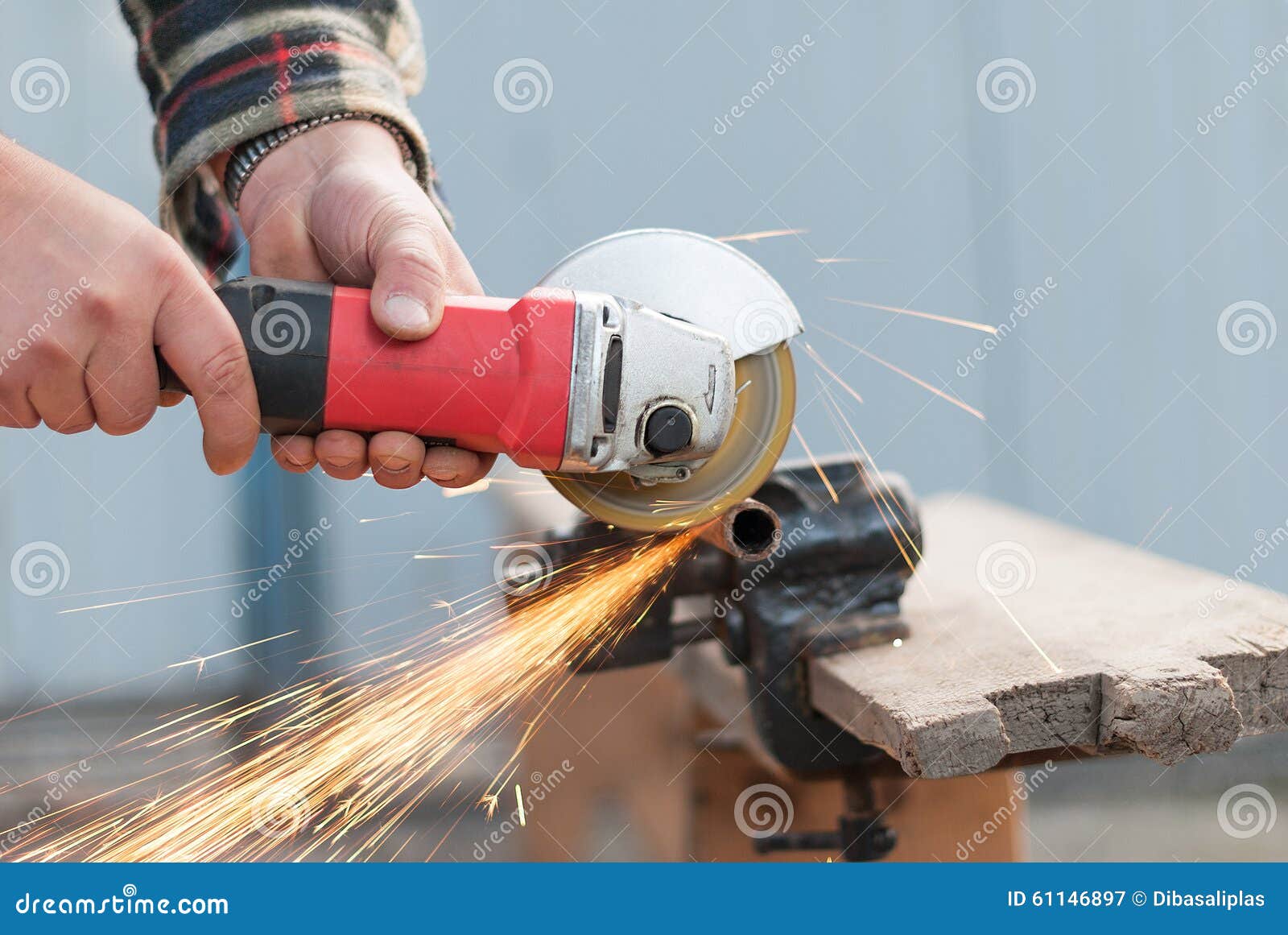 Man cuts a metal grinder. stock image. Image of cutting - 61146897