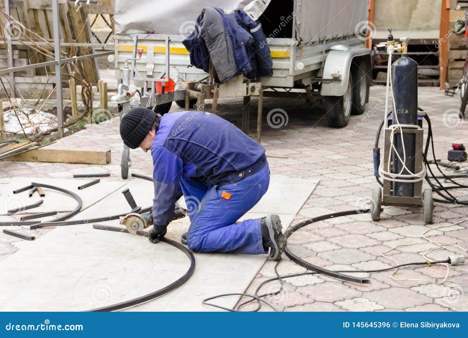 A Man Cuts Metal Squares with a Grinder Stock Photo - Image of industry ...