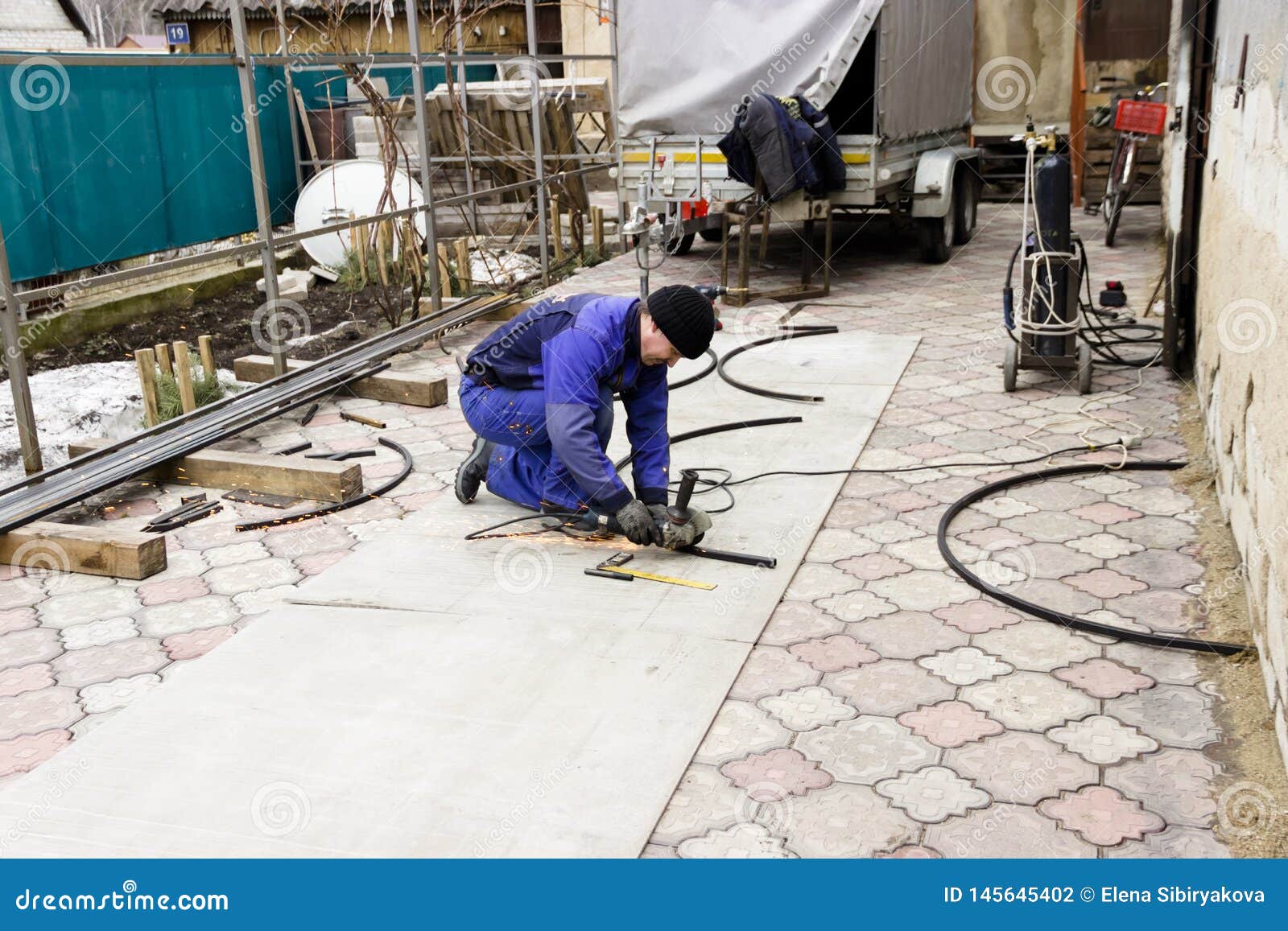 A Man Cuts Metal Squares with a Grinder Stock Photo - Image of ...