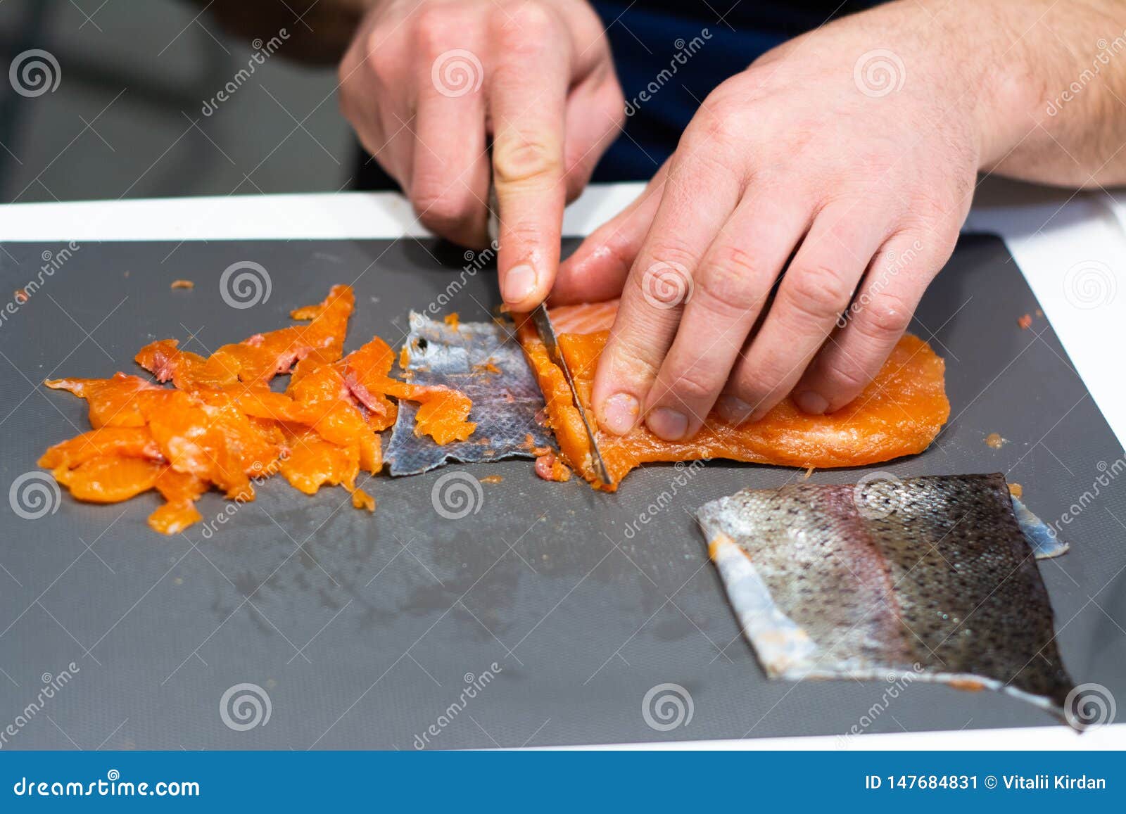 A Man Cuts Red Fish into Pieces. Stock Image - Image of food, chef ...