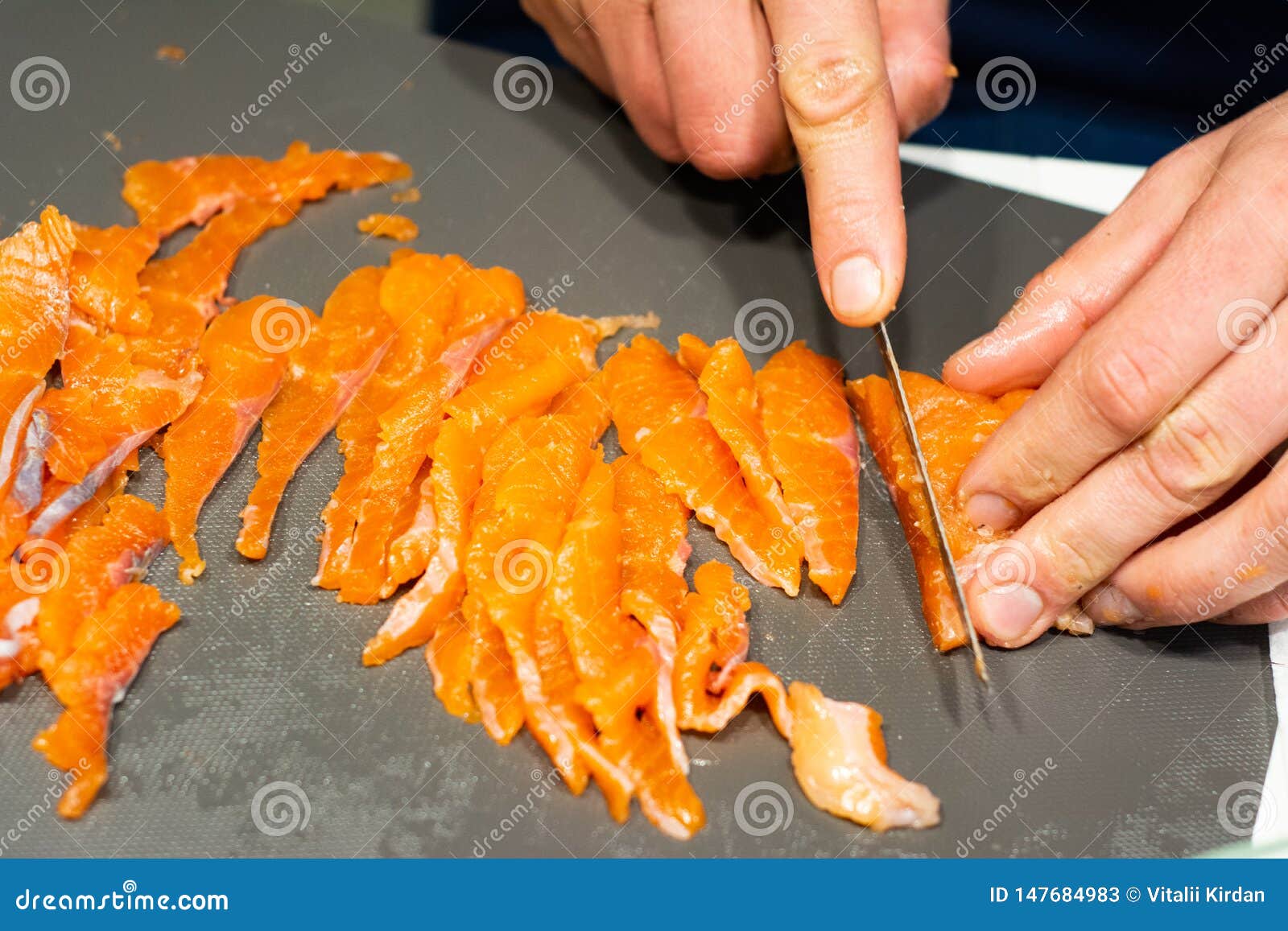 A Man Cuts Red Fish into Pieces. Stock Image - Image of natural ...