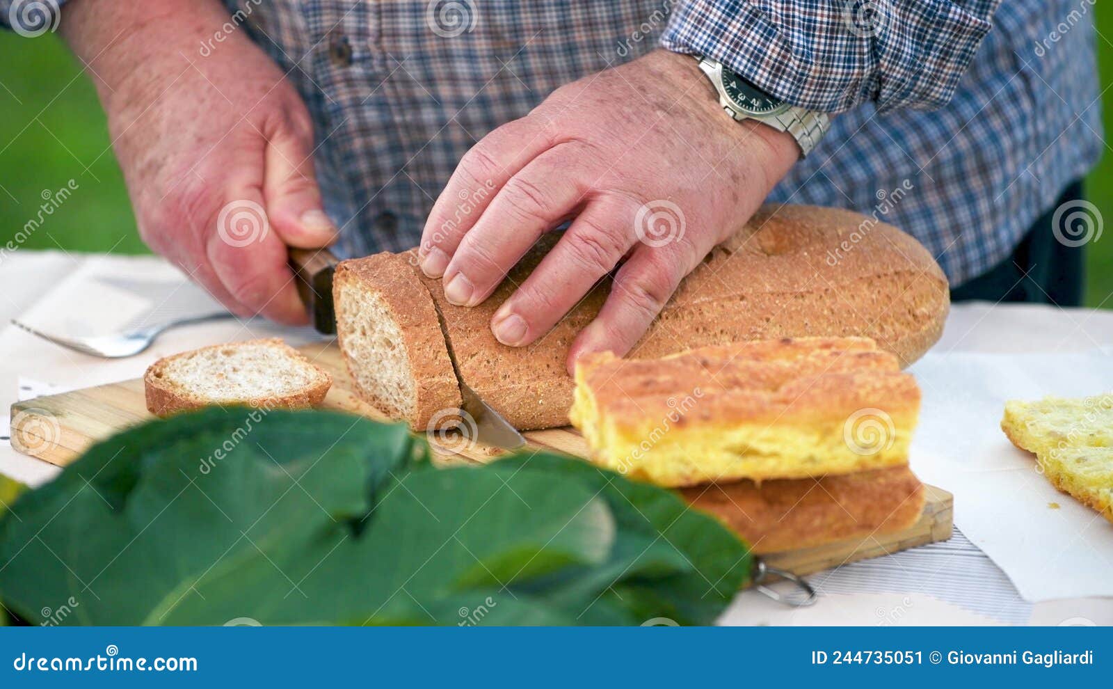 Man Cutting Bread on a Table Outdoor Stock Image - Image of grain ...