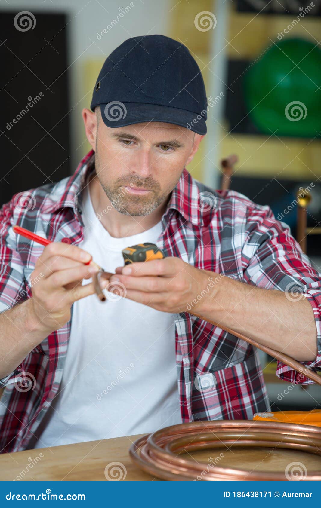 Man cutting copper pipe stock image. Image of metal - 186438171