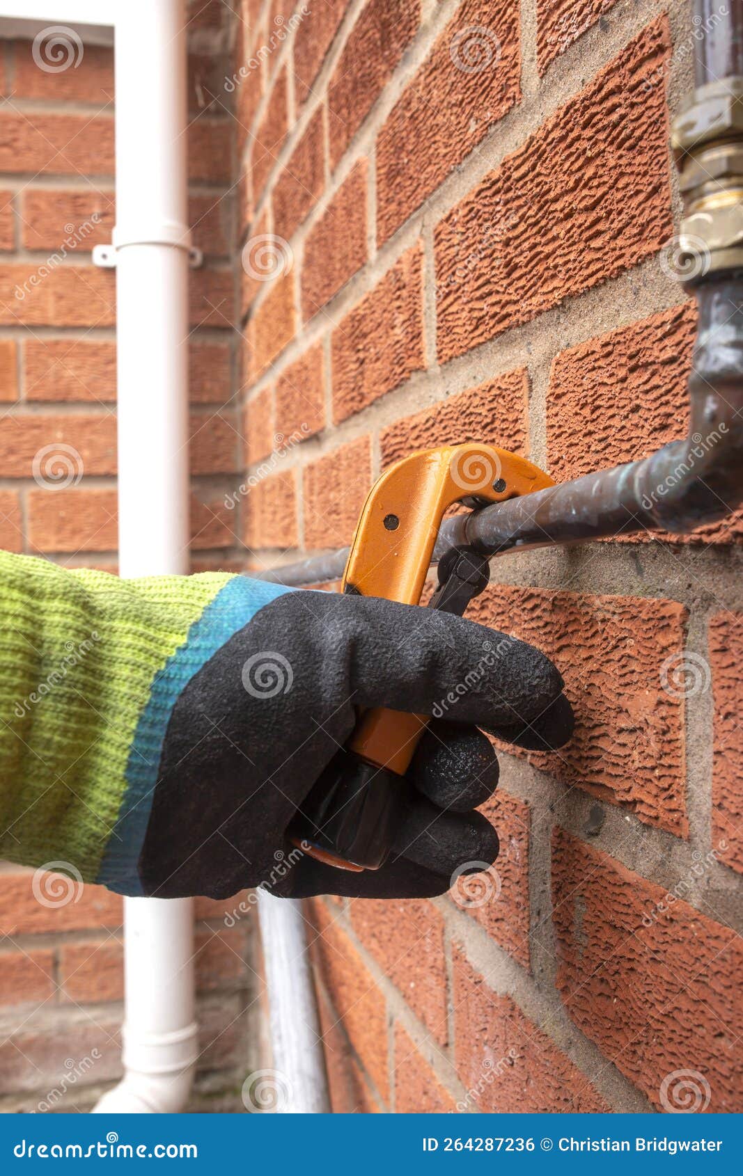 Man Cutting Copper Water Pipe with a Pipe Cutter Tool Outdoors. Stock ...