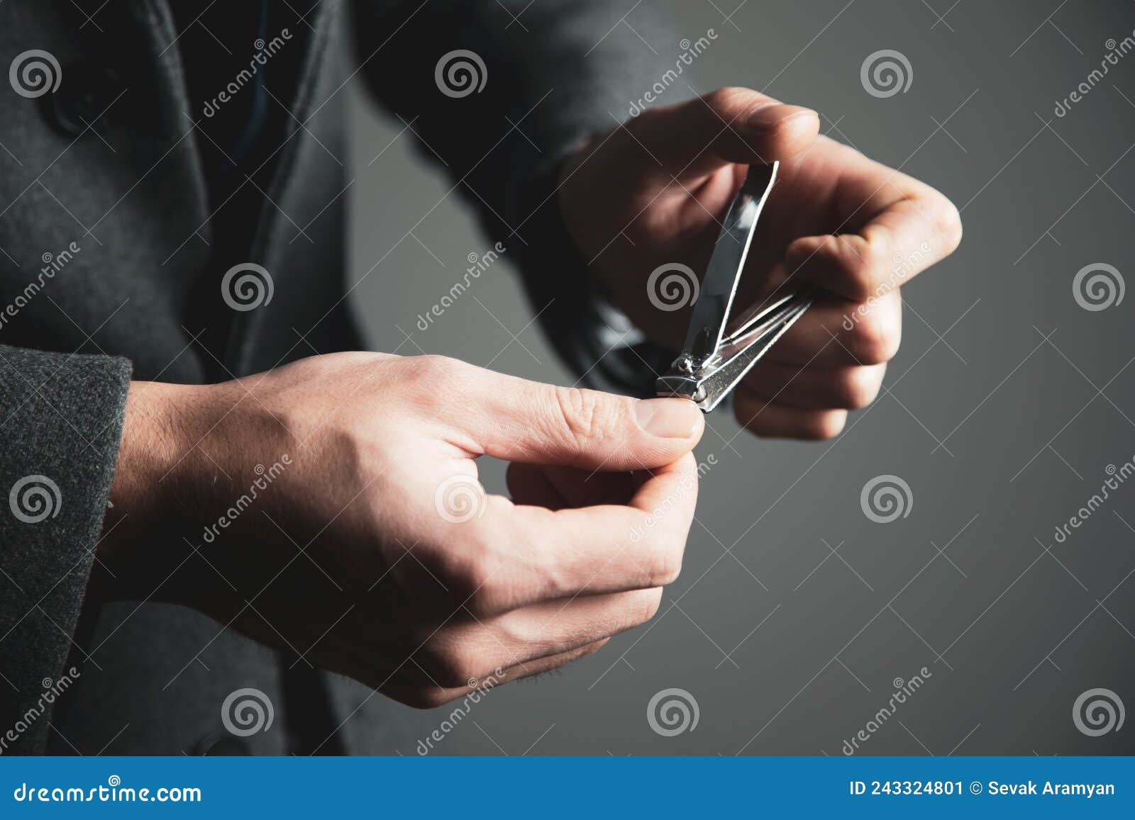 Man Cutting Fingernails with Clipper on Dark Background. Stock Image ...