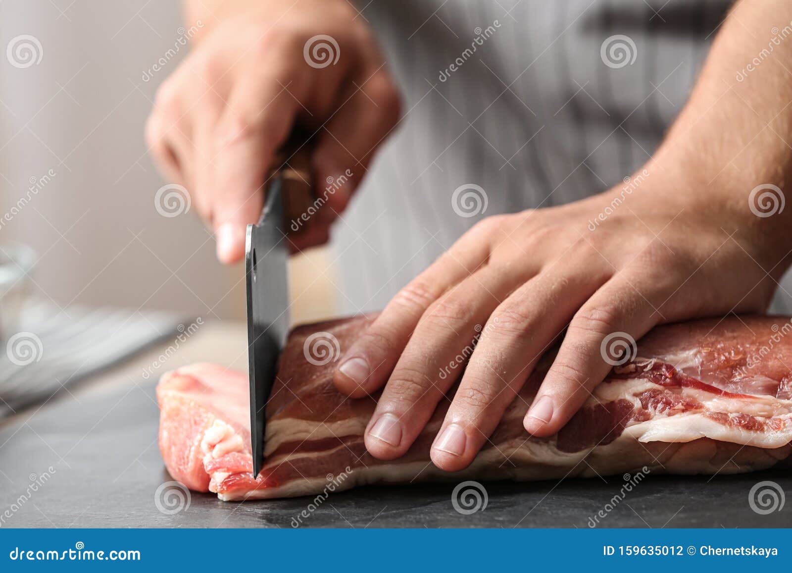 Man Cutting Fresh Raw Meat on Table in Kitchen Stock Photo - Image of ...