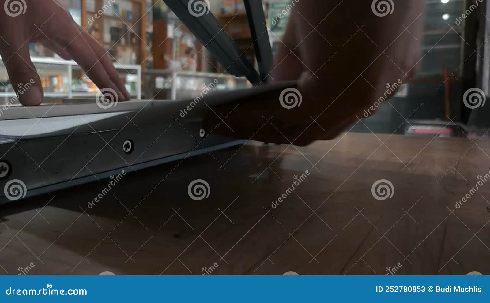 A Man is Cutting Paper Using a Manual Paper Cutter at His Desk Stock ...