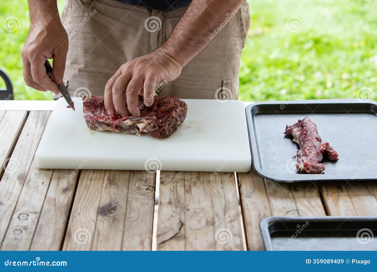 Man Cutting a Piece of Wild Boar Meat. Stock Image - Image of game ...