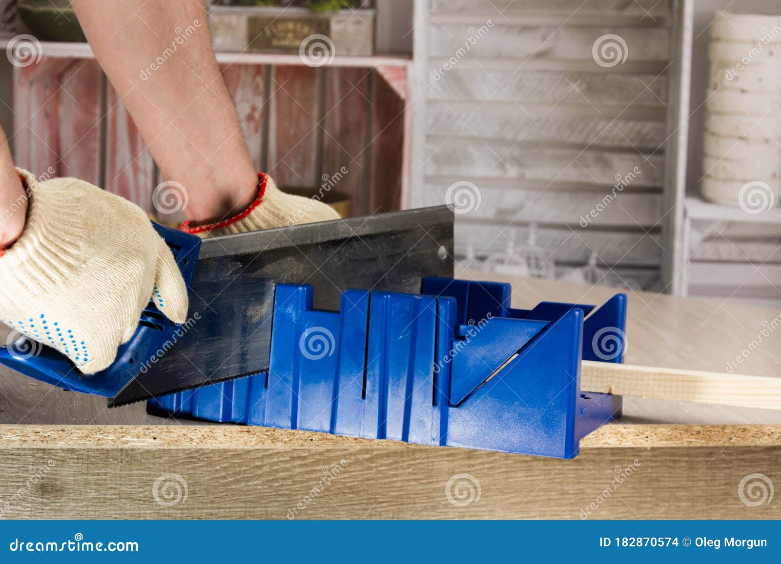 Man Cutting a Slat of Wood Using a Saw and Miter Box Stock Photo ...