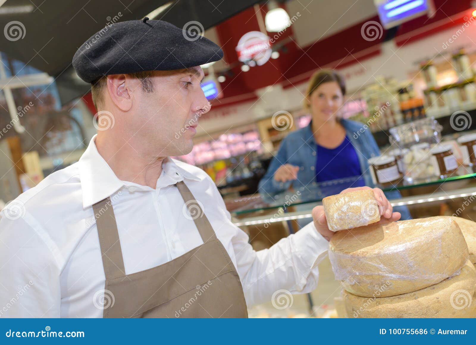 Man cutting wheel cheese stock photo. Image of staff - 100755686