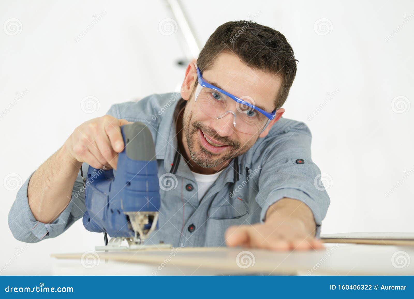 Man Cutting Wood Board on Industrial Machine Stock Photo - Image of ...