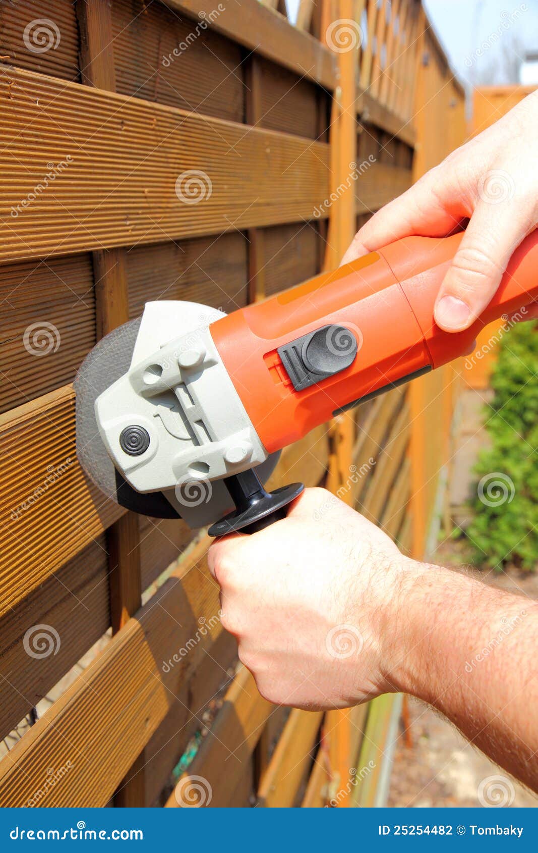 Man cutting wooden fence stock photo. Image of wood, enhancement - 25254482