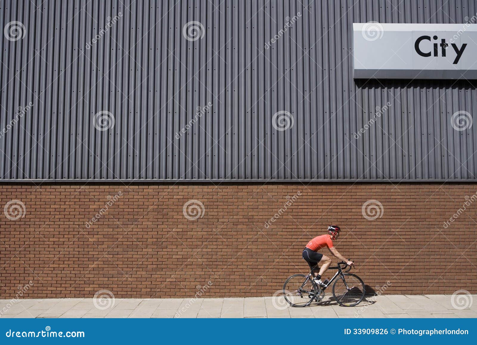 Man Cycling Past Building stock photo. Image of outdoors - 33909826