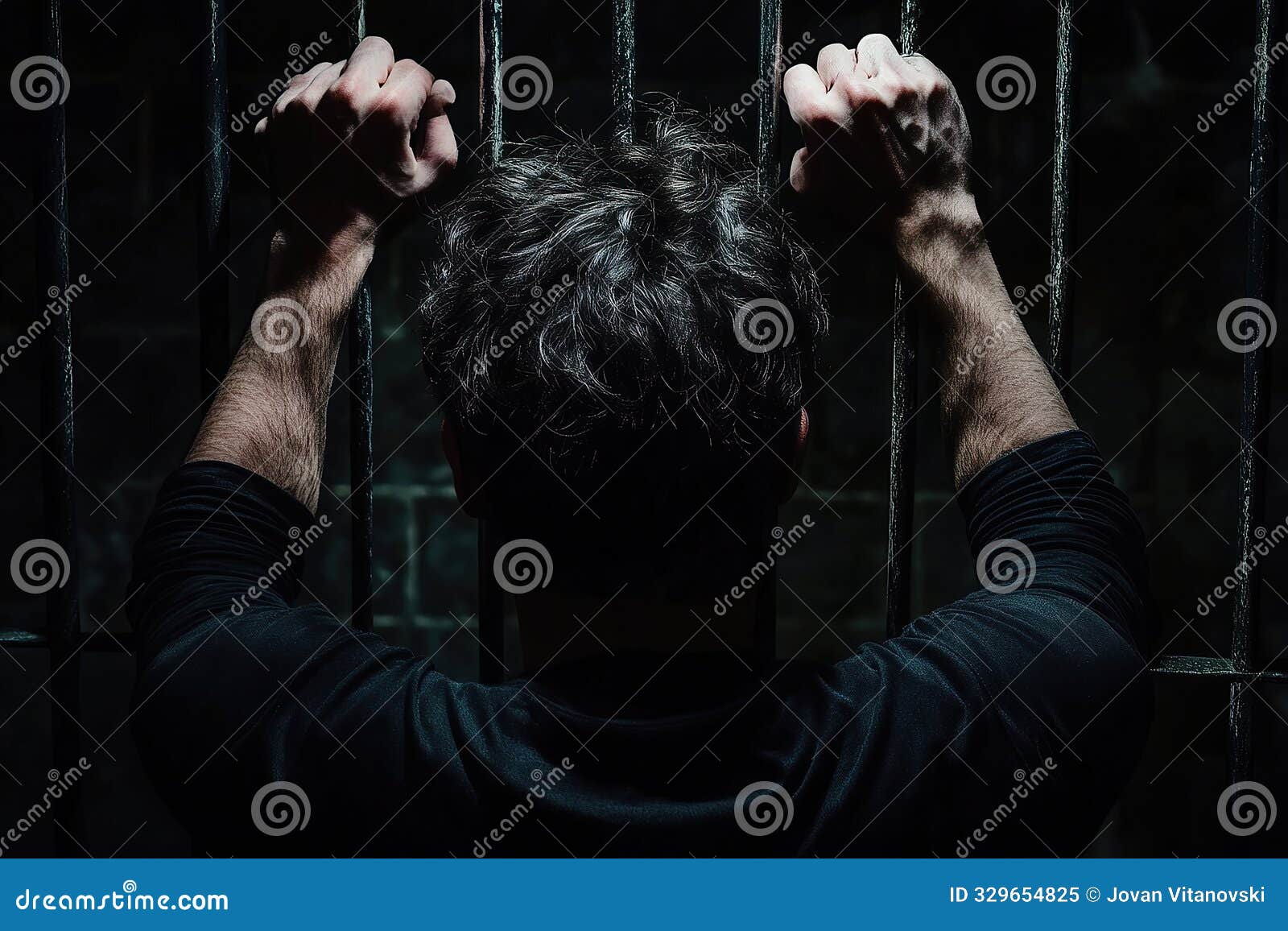 Man in Dark Prison Cell Gripping Bars with Tense Hands Stock ...