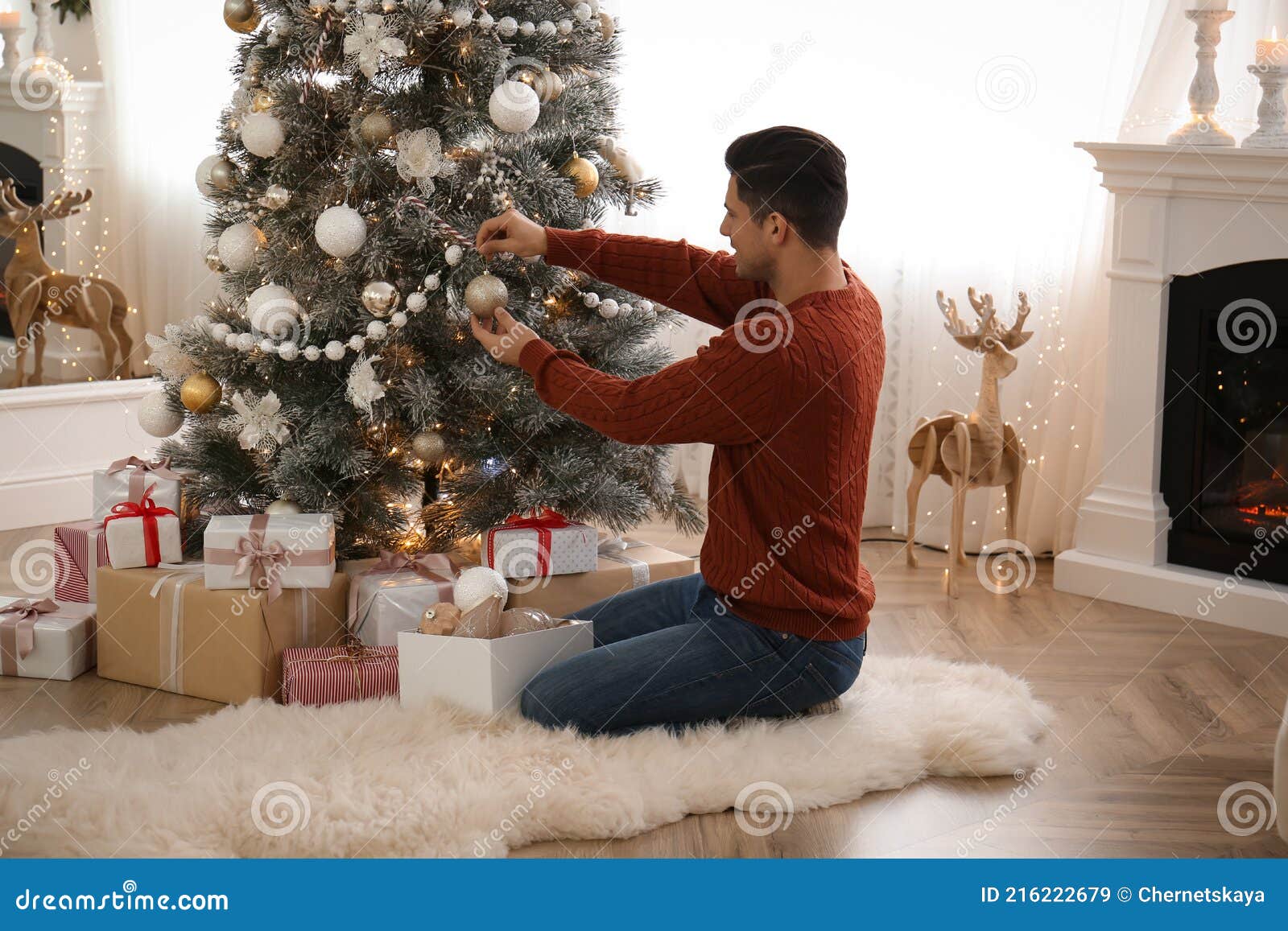 Man Decorating Christmas Tree in Beautiful Room Interior Stock Image ...
