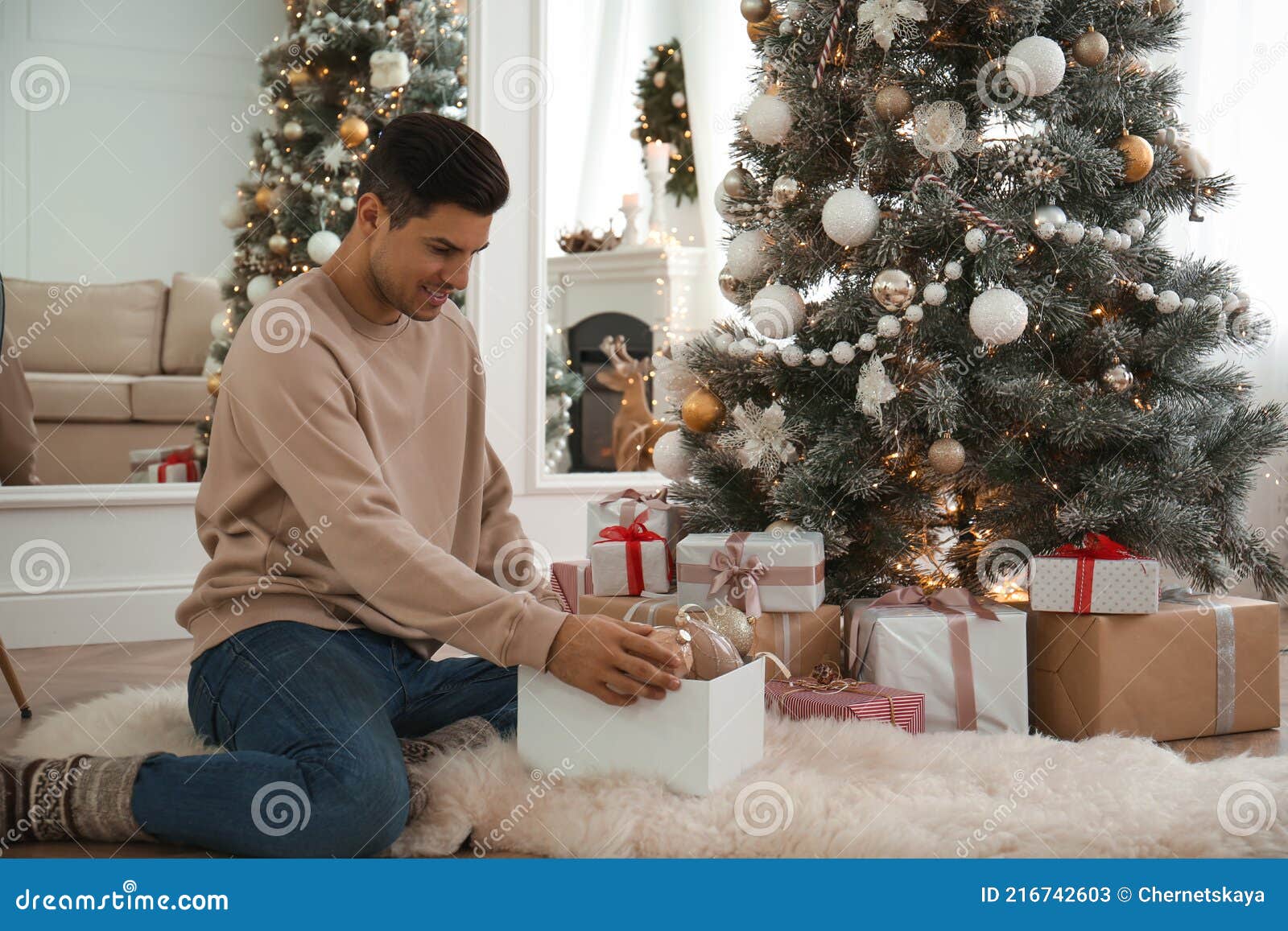 Man Decorating Christmas Tree in Beautiful Room Interior Stock Image ...