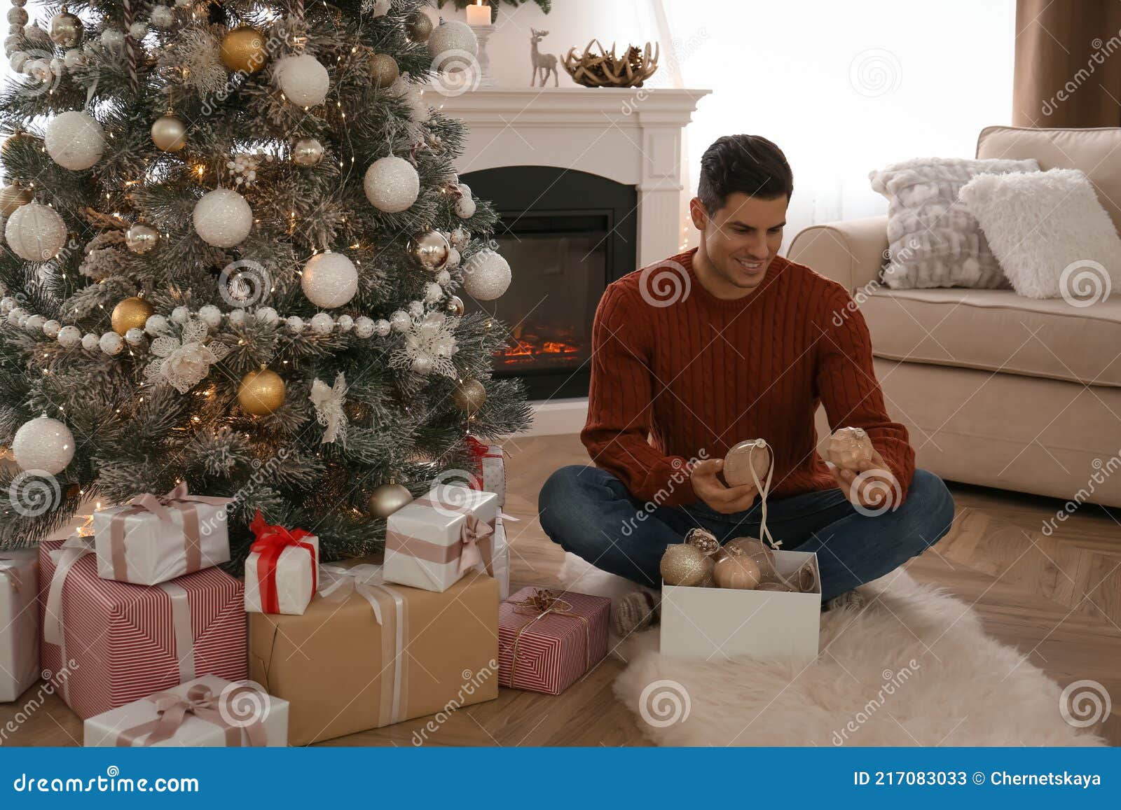 Man Decorating Christmas Tree in Beautiful Room Interior Stock Image ...