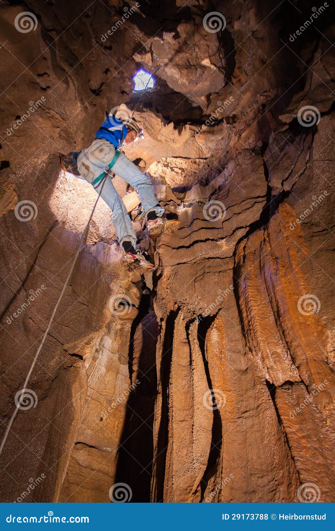 Man descending into cave stock photo. Image of safe, enter - 29173788