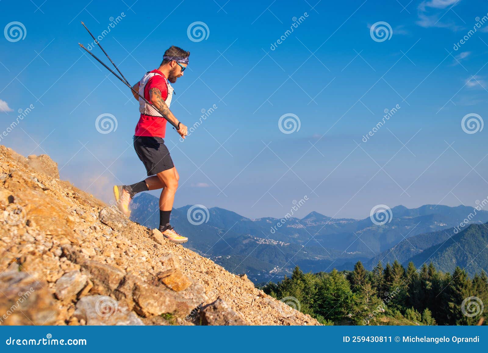 Man Descending with Poles on a Rocky Slope Stock Image - Image of ...