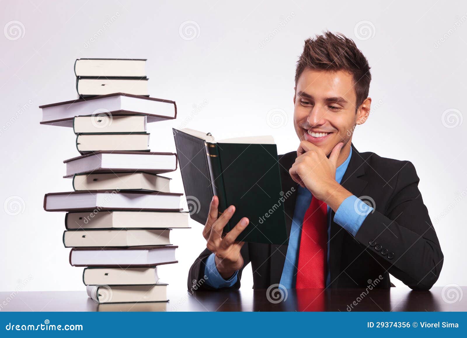 Man at desk reading book stock photo. Image of intellingent - 29374356