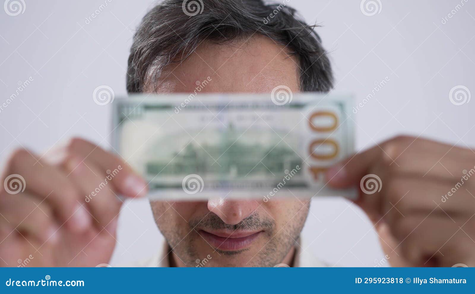 A Man Determines the Authenticity of a Hundred Dollar Banknote Stock ...