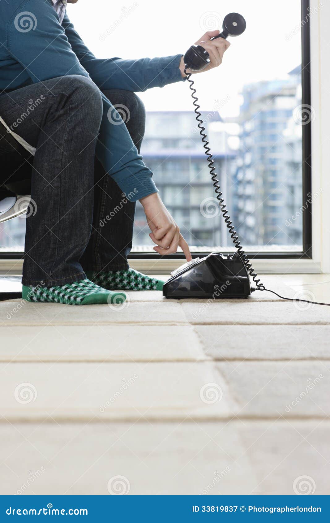 Man Dialing Phone at Home stock image. Image of apartment - 33819837