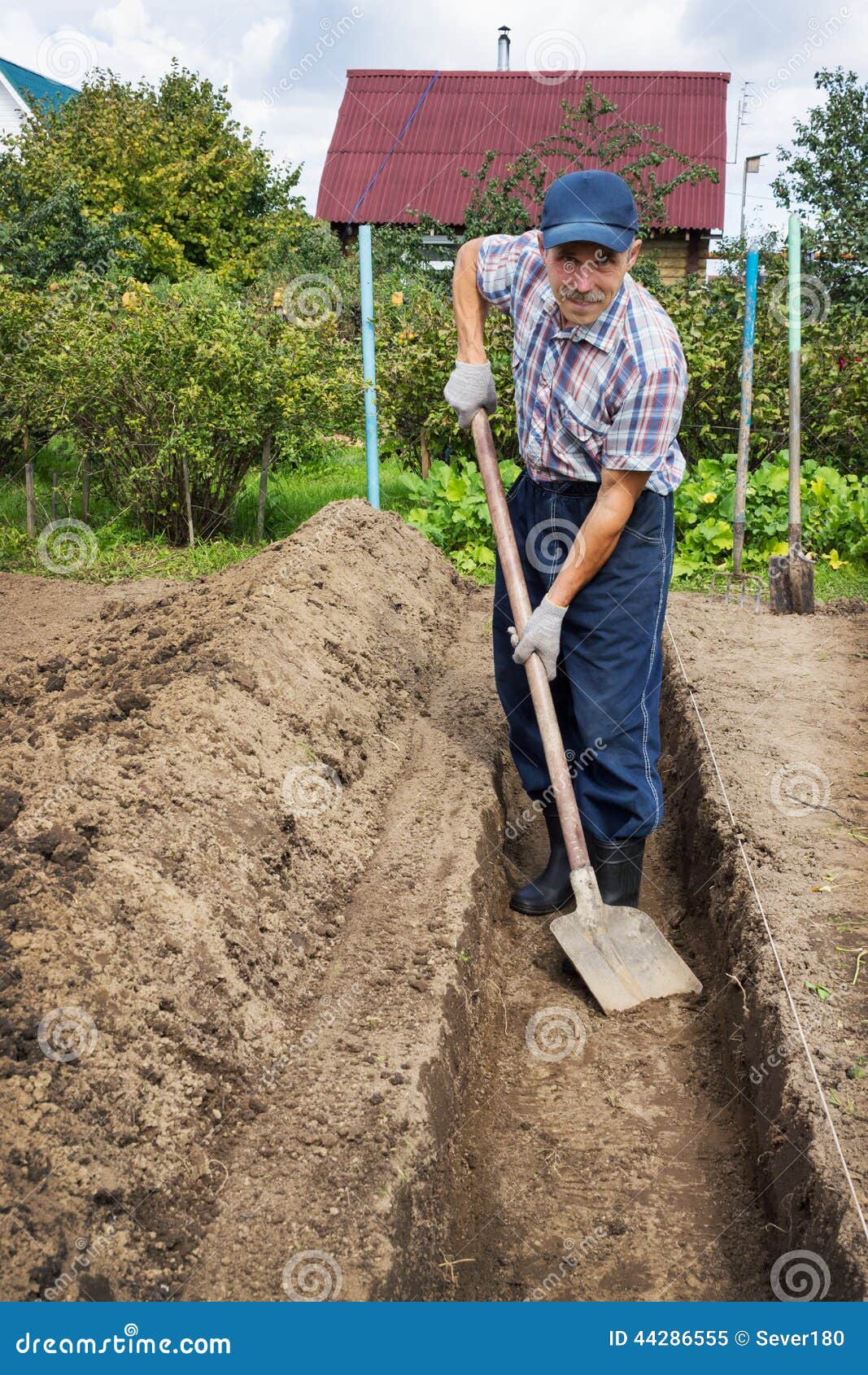 Man Digging the Earth To Build a Deep Bed of Stock Image - Image of ...