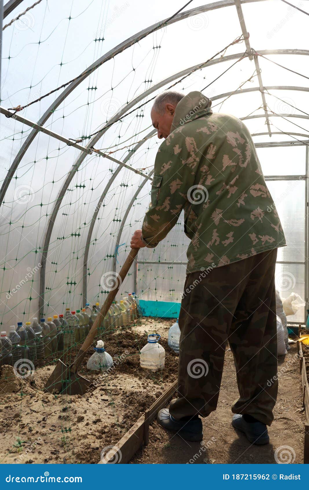 Man Digging Soil in Greenhouse Stock Photo - Image of farming ...
