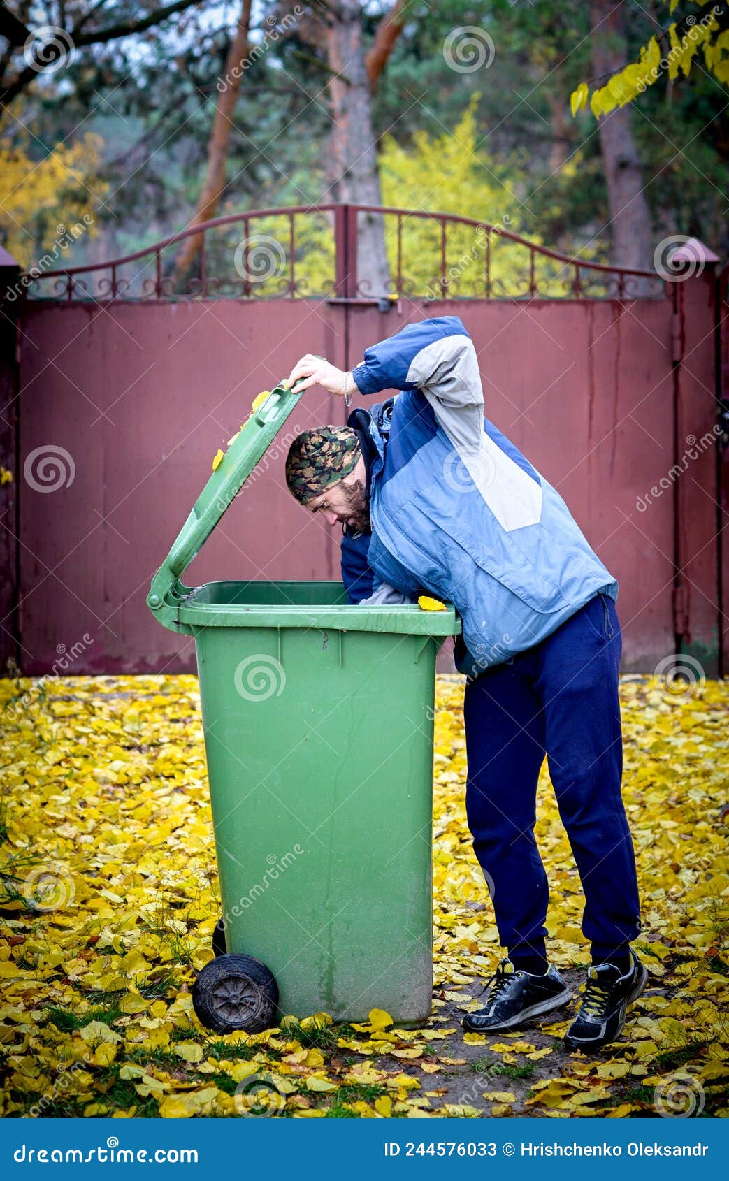 A man digs in a trash can stock image. Image of miserable - 244576033