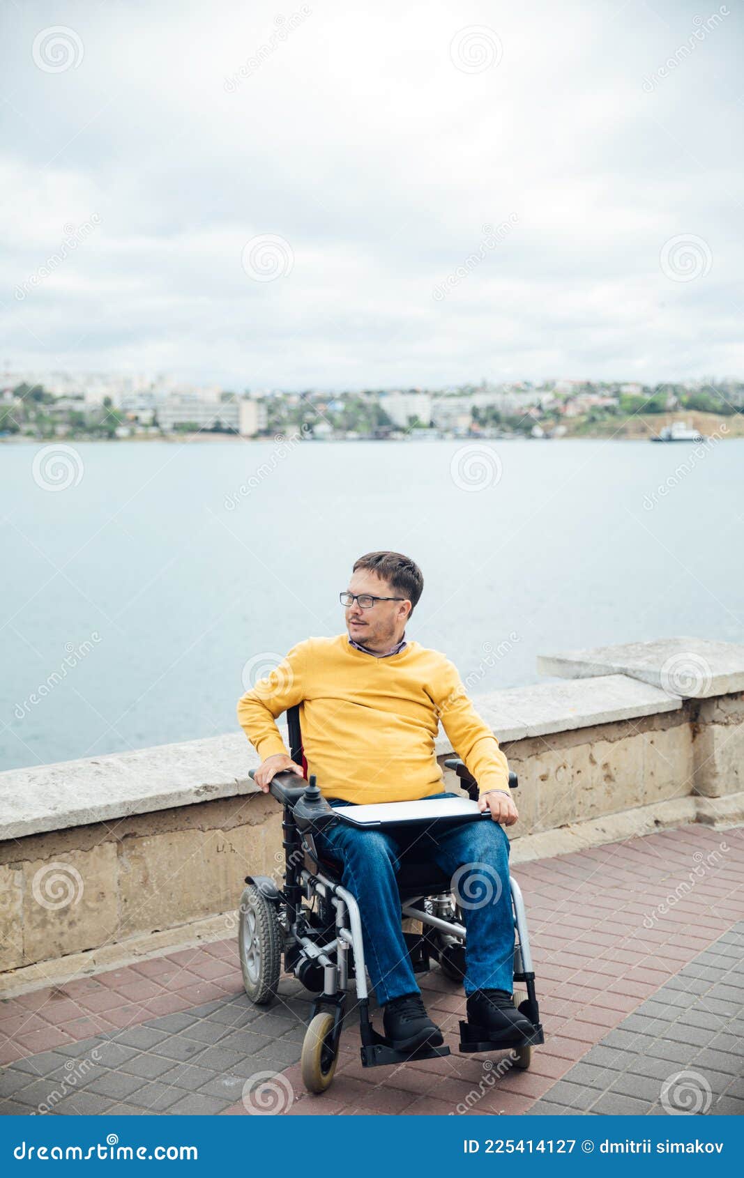 A Man with Disabilities in a Wheelchair Walking Looks at the View Stock ...
