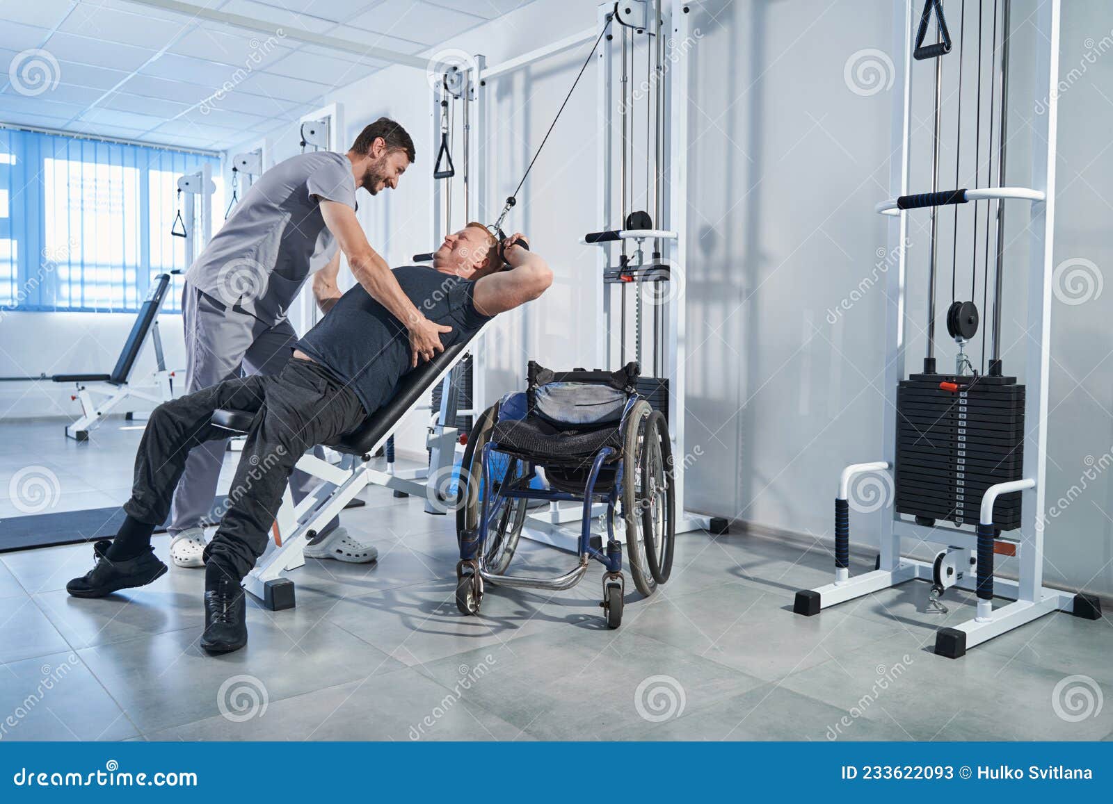 Man with Disability Doing Exercise on Strength Machine with Therapist ...