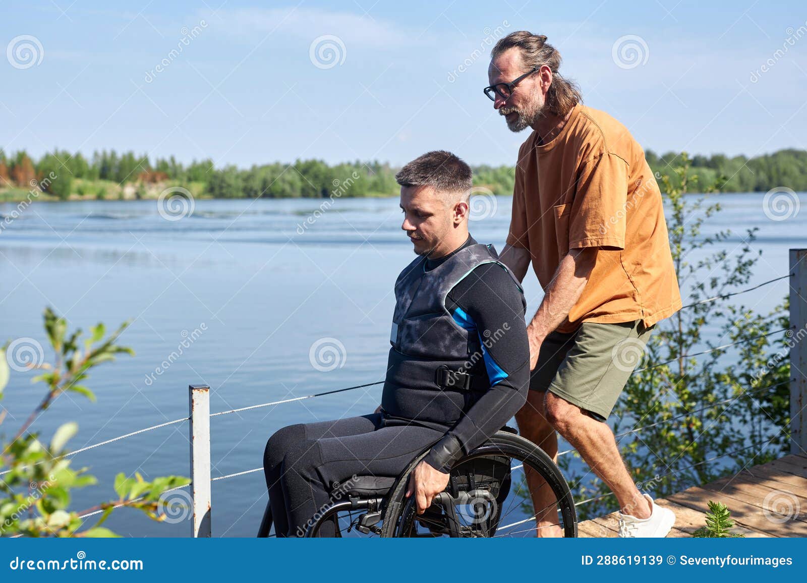 Man with Disability Ready To Scuba Dive with Instructor Assisting Stock ...