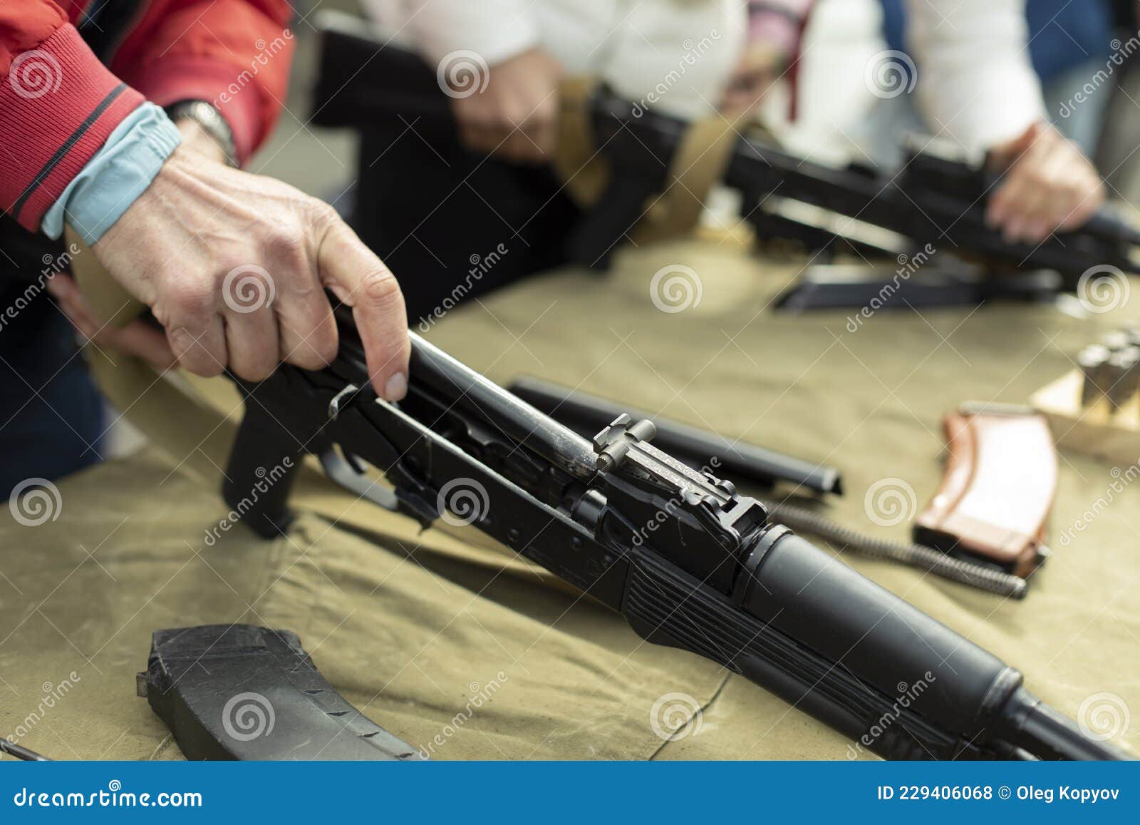 A Man Disassembles a Firearm. a Person Undergoes Military Training ...