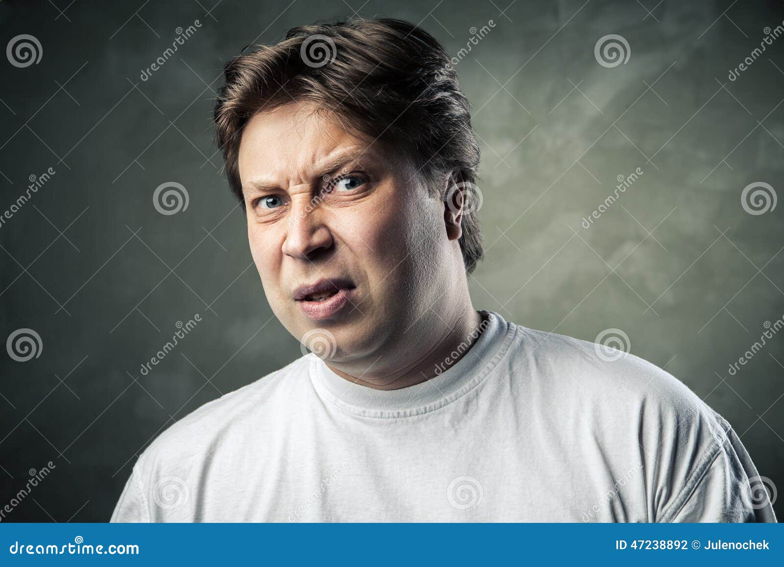 Man with Disgusted Expression Over Dark Grey Stock Photo - Image of ...