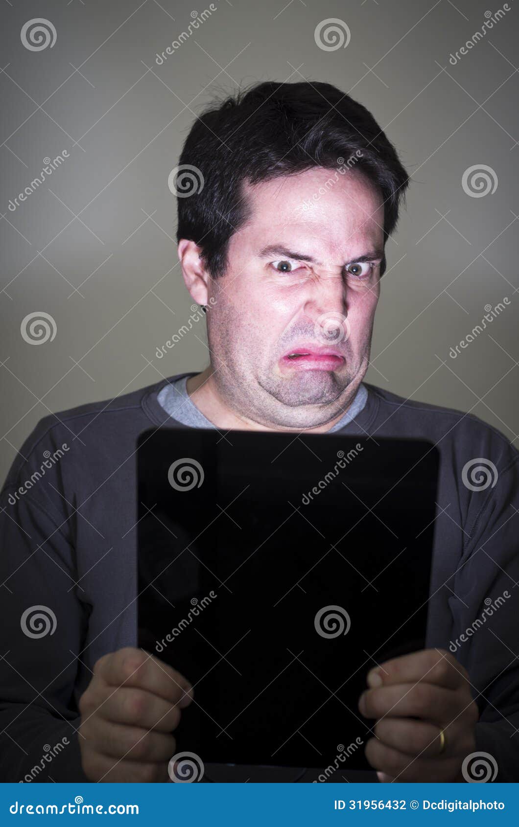 Man is Disgusted by What he Sees on a Tablet Device Stock Photo - Image ...