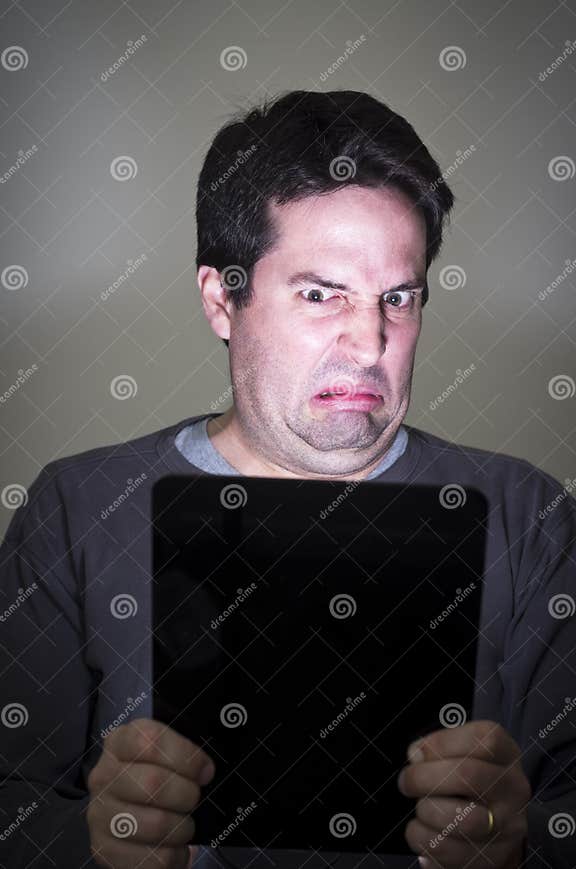 Man is Disgusted by What he Sees on a Tablet Device Stock Photo - Image ...
