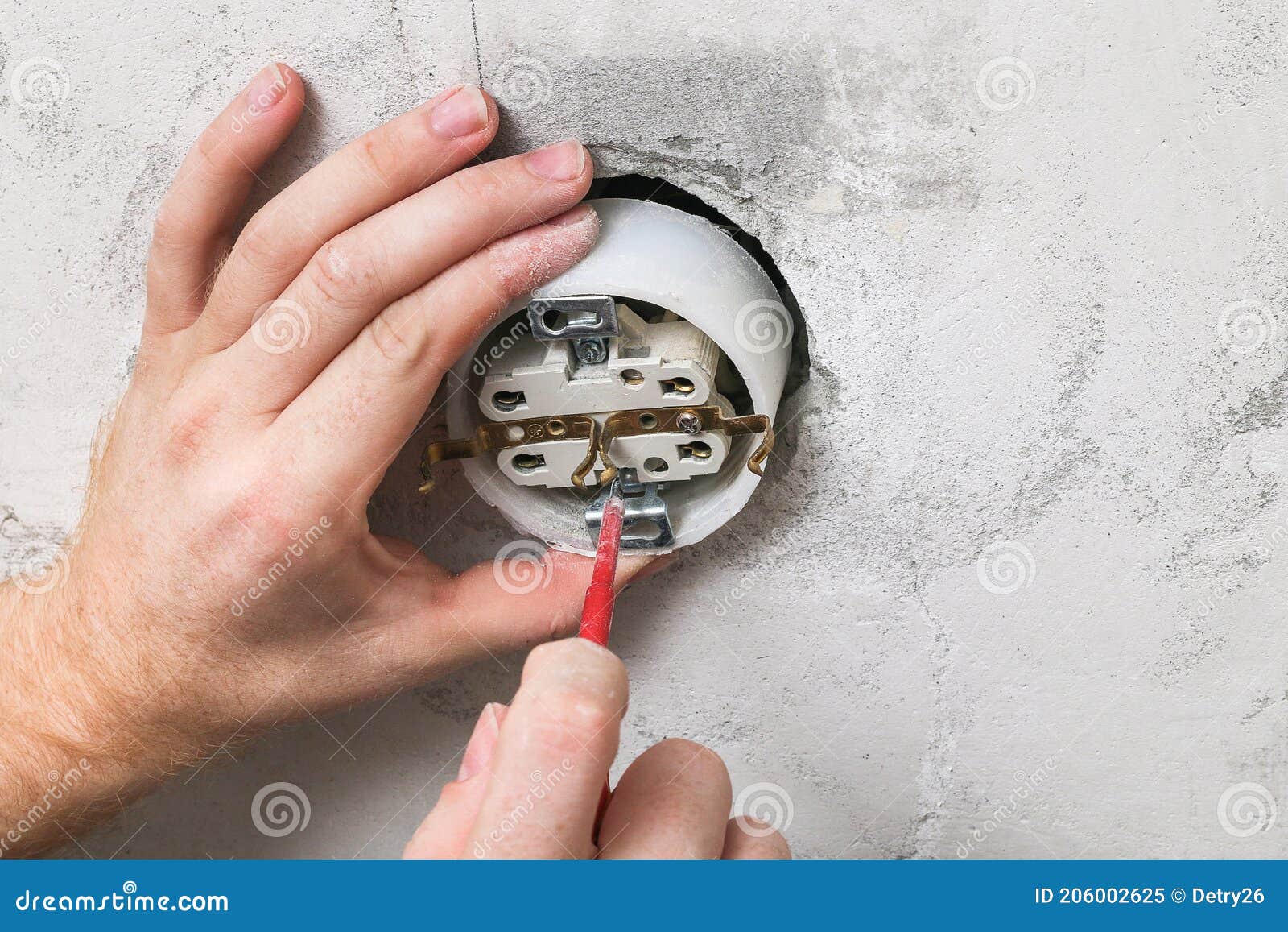A Man Dismantles and Mends Electrical Outlet for Repairs. Power Socket ...