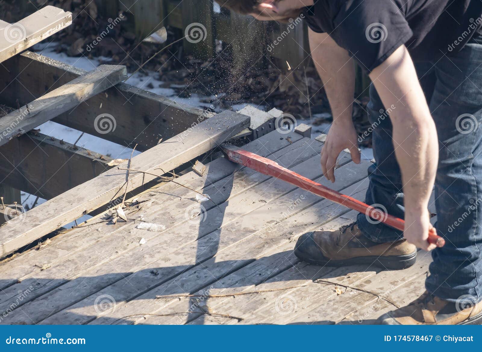 Man Dismantling an Old Wooden Deck with a Red Crowbar 1 Stock Image ...