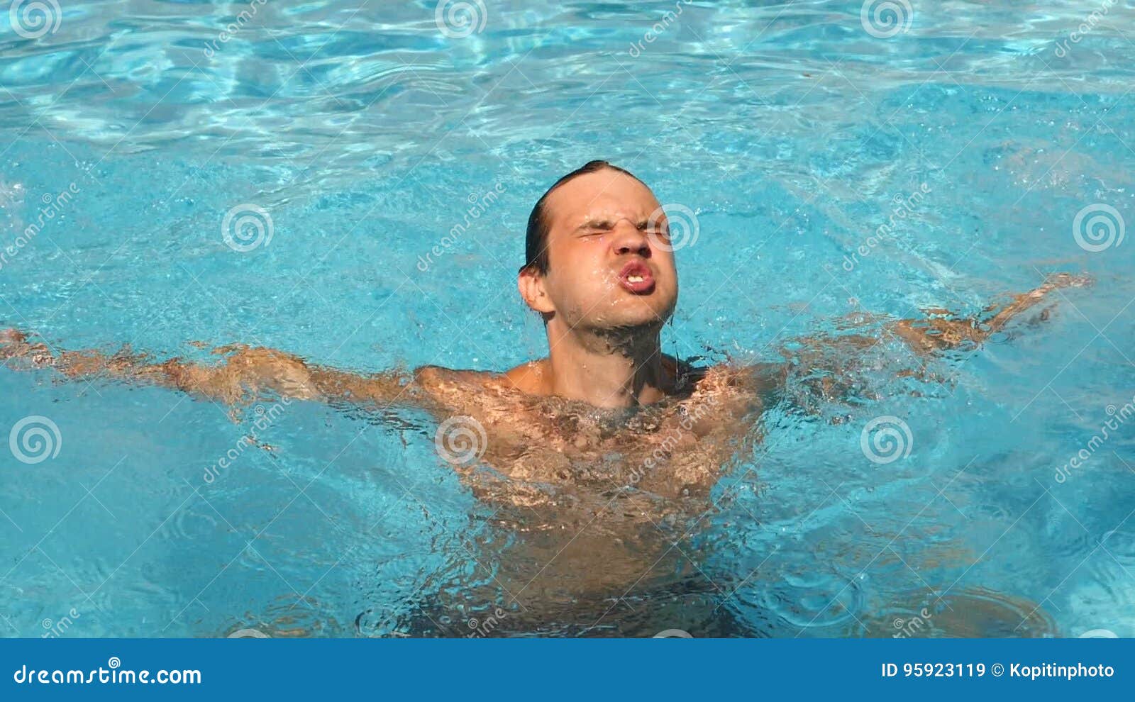 A Man Dives into the Pool with Blue Water. Splashes Fly in Different ...